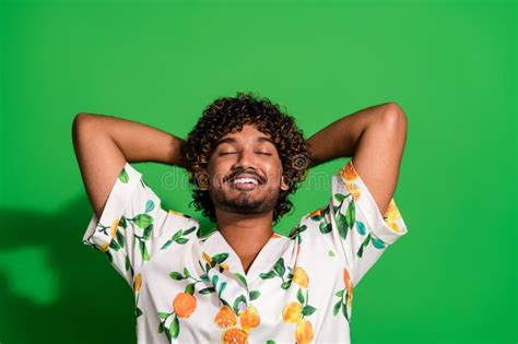 Photo Of Funky Dreamy Arabian Man Wear Print Shirt Closed Eyes Arms Behind Head Isolated Green