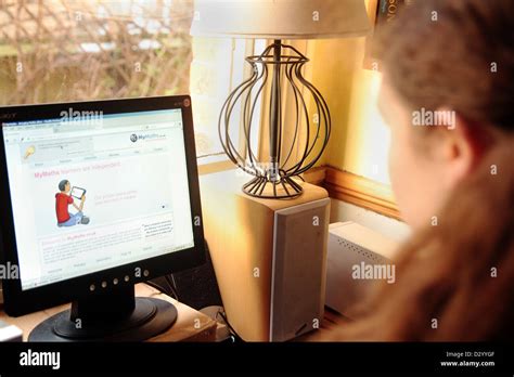 A Teenage Girl Does Her Homework Using The Computer At Home Stock Photo Alamy