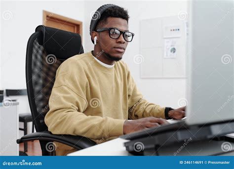 Young Contemporary Serious Male It Programmer Looking At Computer