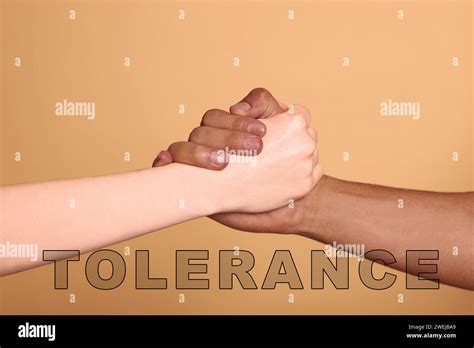 Tolerance Support And Cooperation Concept People Of Different Races Clasping Hands On Light