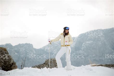 클로즈업 보기 아름 다운 젊은 여성 겨울 옷에 옆으로 서 보유 하 고 배경에 손에 막대기 눈 산 겨울에 대한 스톡 사진 및 기타 이미지 Istock