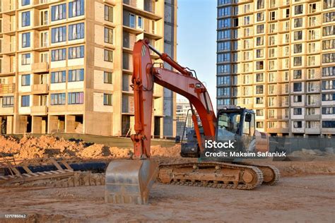 토목 공사 현장에서 작업하는 굴삭기 백호 파고 건물 기초 하수도 라인을 포장합니다 화물의 굴착 적재 리프팅 및 운반을 위한 건설