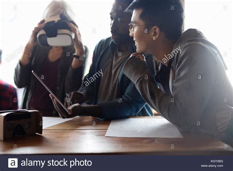 Designers And Computer Programmers With Digital Tablet Testing And