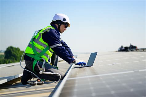 태양전지 농장 발전소 옥상에서 노트북 점검 및 운영 체제를 사용하는 엔지니어 기술자 전기 및 전력용 재생 에너지원 태양전지 유지보수 개념 건설 산업에 대한 스톡 사진 및