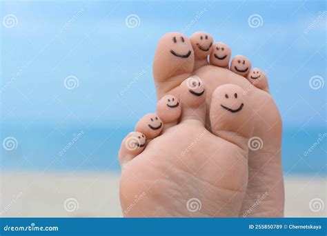 Woman With Smiling Faces Drawn On Toes Outdoors Closeup Of Feet Space For Text Stock Image