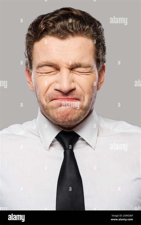 Businessman Grimacing Frustrated Young Man In Shirt And Tie Keeping