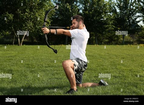 Man With Bow And Arrow Practicing Archery In Park Stock Photo Alamy