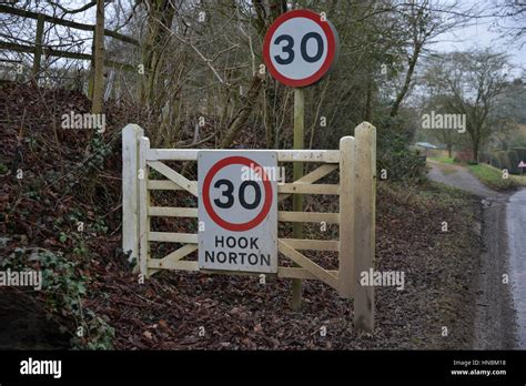 Mph Speed Limit Sign And Signpost On The Way Into The North Oxfordshire Village Of Hook Norton