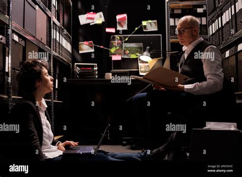 Criminology Team Working Overtime At Missing Person Case Analyzing Victim Report In Arhive Room