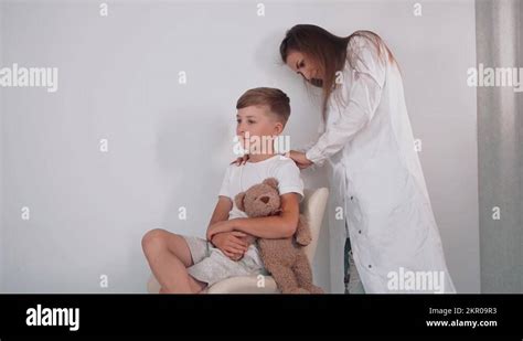 Female Doctor In A White Lab Coat Regularly Examines A Cute Babe In The Clini Stock Video Footage