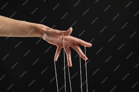 Premium Photo Woman Pulling Strings Of Puppet On Black Background Closeup