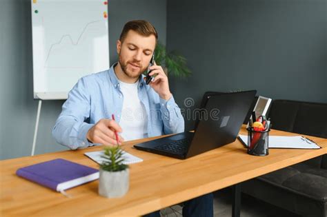 Computer Programmer Writing Program Code On Computer In Office Stock