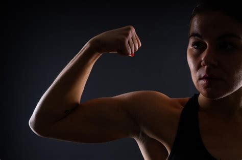 Premium Photo Close Up Of Young Woman With Arms Raised Against Black