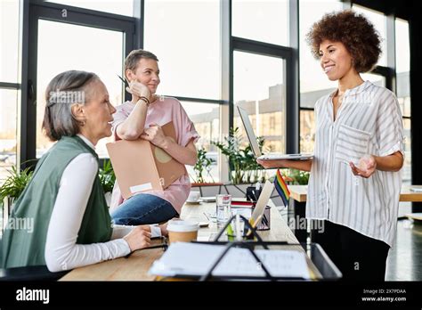 Hardworking Diverse Women Gathered Around A Table Collaborating In An Office Setting Stock