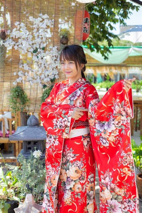 The Girl Is Wearing A Red Traditional Kimono Which Is The National