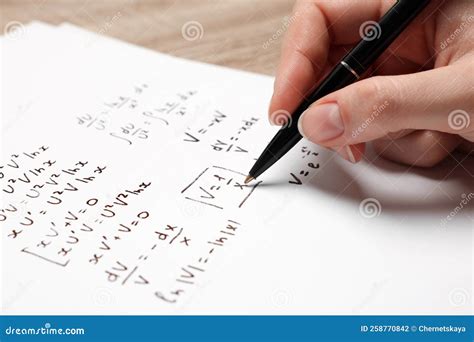 Student Writing Different Mathematical Formulas On Paper Closeup Stock