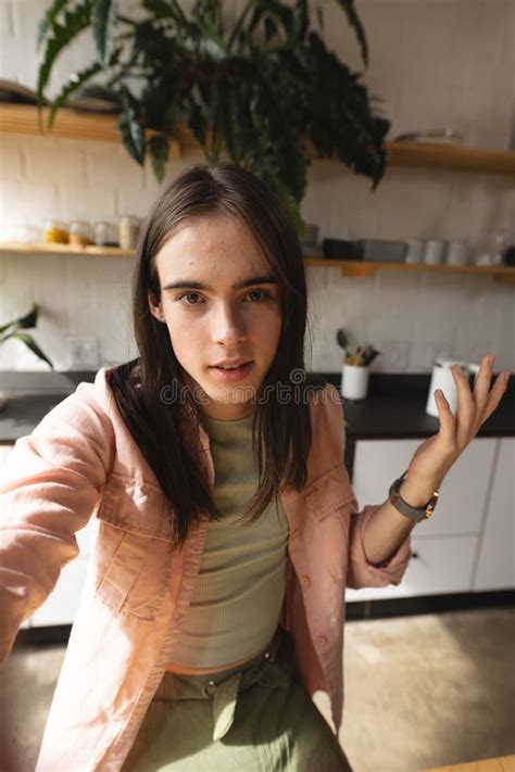 Portrait Of Non Binary Trans Woman Looking At The Camera In The Kitchen At Home Stock Image