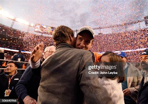 Quarterback Peyton Manning Of The Denver Broncos Gets A Hug From