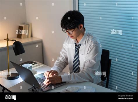 Overwork Concept The Man Sitting At His Desk And Focusing On Working Through His Computer Laptop