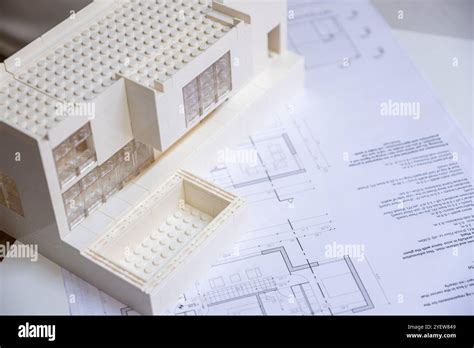 Close Up Of A Lego Architectural Model On Top Of Detailed Building Plans Symbolizing Creativity