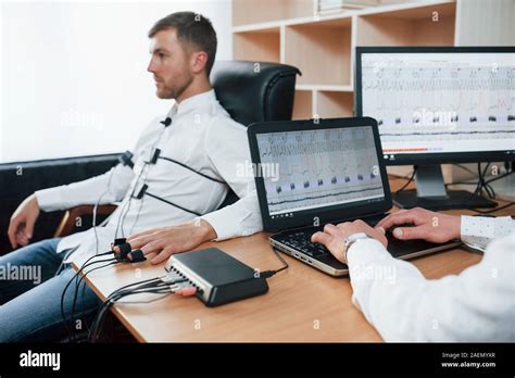 Tense Look Suspicious Man Passes Lie Detector In The Office Asking