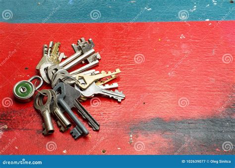 the combination of fifteen different keys and a padlock lying on the plane copy space stock