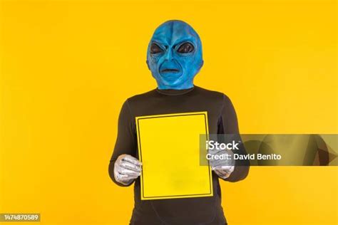 Pria Bertopeng Alien Dengan Kepala Biru Memegang Tanda Kuning Konsep Aneh Luar Angkasa Lucu