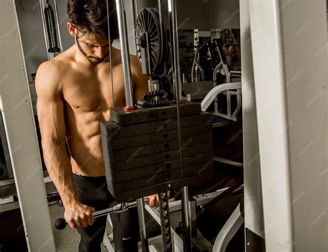 Premium Photo Naked Torso Muscular Man Working Out In Gym Doing