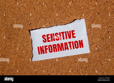 Sensitive Information Words Written On Ripped White Paper Piece With Brown Background