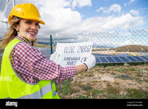A Female Engineer At A Solar Power Plant With A Sheet That Says Clean
