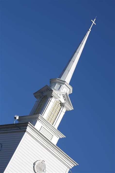 White Church Steeple Against Blue Sky