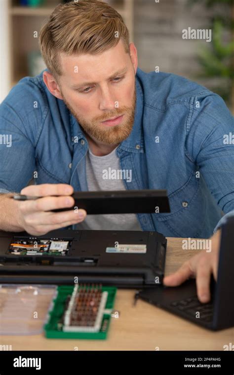 Man Fixing Circuit Board In Laptop Using Screwdriver Stock Photo Alamy
