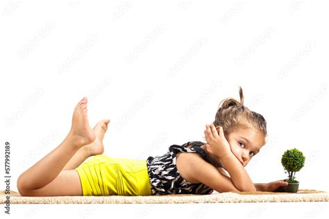Cute Litthe Girl Lying On The Ground And Playing With Tiny Babe Toy
