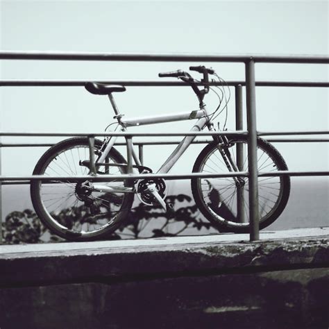 Premium Photo Bicycle Amidst Railings Against Clear Sky