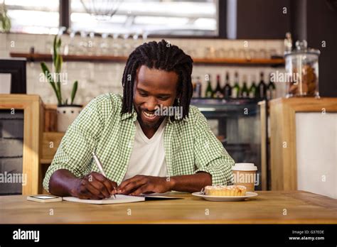 Man Writing In A Notebook Stock Photo Alamy