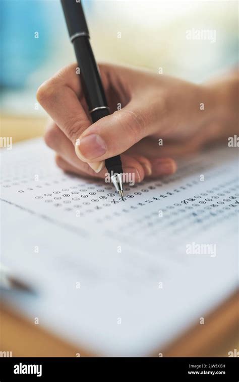 Hoping To Pass This Test A Woman Filling In An Answer Sheet For A Test