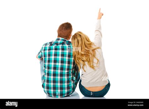 Back View Of Couple Sitting On White Background And Showing Copy Space