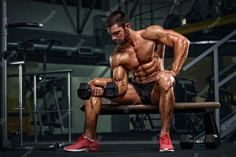 Premium Photo Muscular Men Exercise With Weights Performing Dumbbell