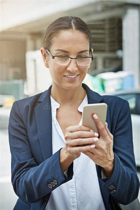 Keeping Her Inbox Updated On The Go A Young Businesswoman Using Her Phone While Out In The City