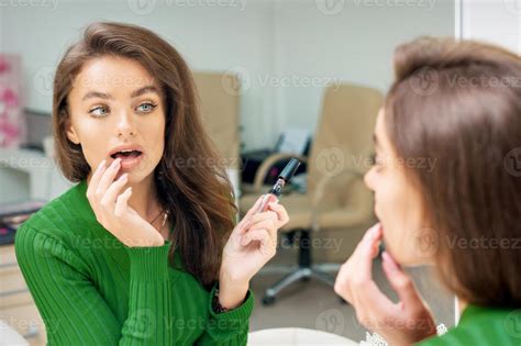 Woman Applying Gloss To The Lips 20569997 Stock Photo At Vecteezy