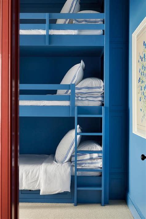 Blue Wooden Triple Bunk Bed With White And Blue Hotel Bedding