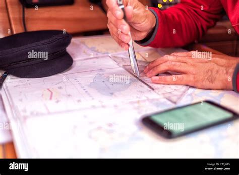 Navigation With Sea Charts In The Chart Room On A Sailing Yacht Stock Navigation With Sea Charts In The Chart Room On A Sailing Yacht Stock