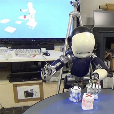 icub robot manipulating an object on the reactable from the