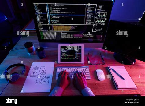 Concentrated Male Software Developer Wrapped Up In Work While Sitting