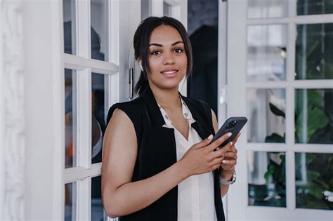 집에서 사랑스러운 미소로 카메라를 바라보는 아프리카계 미국인 여성의 초상화를 닫습니다 자신감 넘치는 예쁜 브라질 소녀가 사무실에서 휴식을 취하고 있다 모형 행복한 사람들