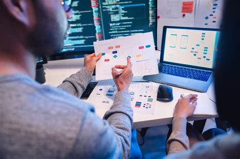 Asian Software Developers Teams Working On Multiple Screens Displaying Code And Application