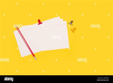 Blank Striped Paper Notes With A Red Pencil On A Yellow Background With