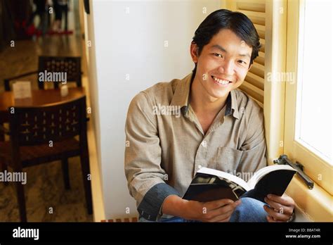 Man Holding Book Smiling Stock Photo Alamy