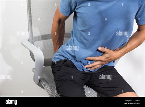 A Man Sitting Farting On The Chair Because There Is Acid In The Stomach