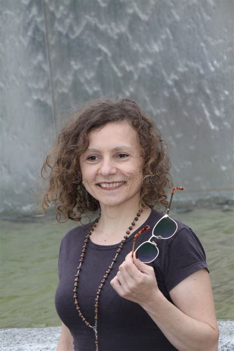 Portrait Of An Attractive Woman Sunglasses In Her Hand Stock Image